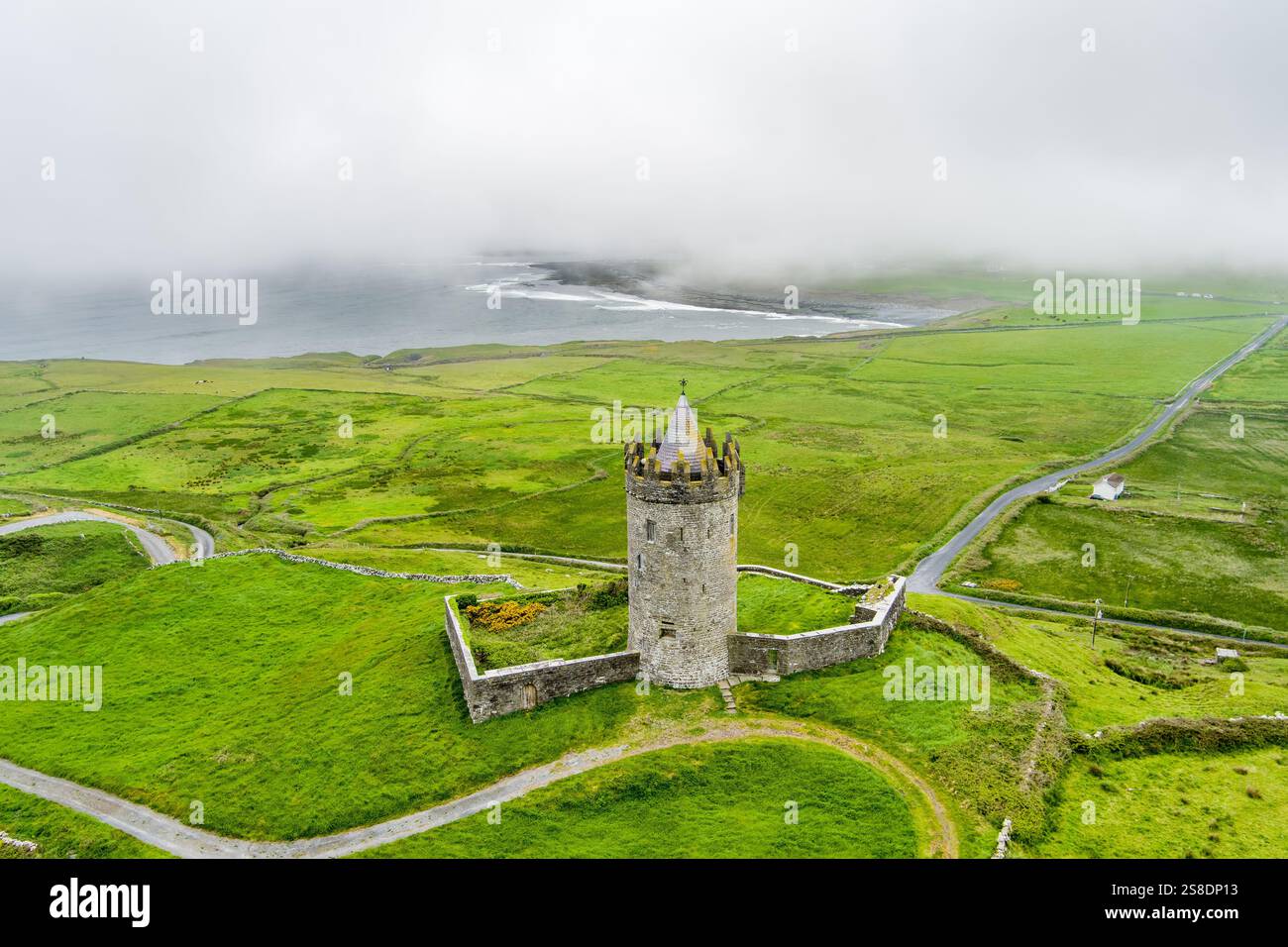 Aerial view of Doonagore Castle, round 16th-century tower house with a ...