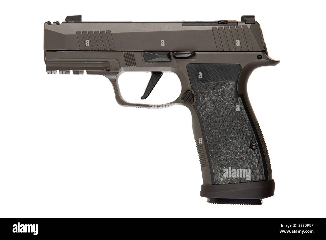 Khaki-colored handgun with a textured grip, side view, isolated on a ...