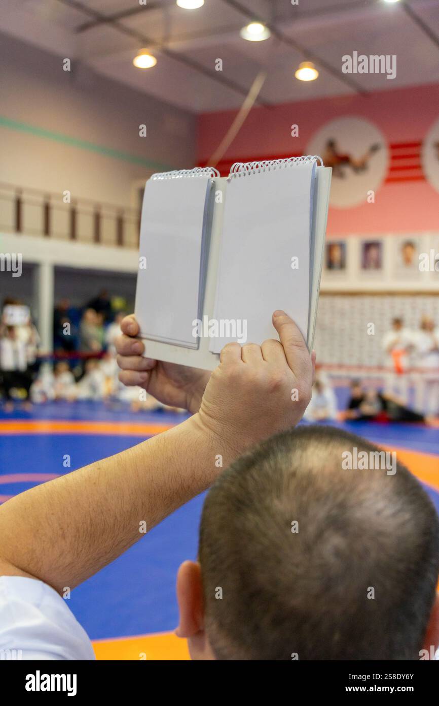 The karate referee shows marks during martial art competition. Copy ...
