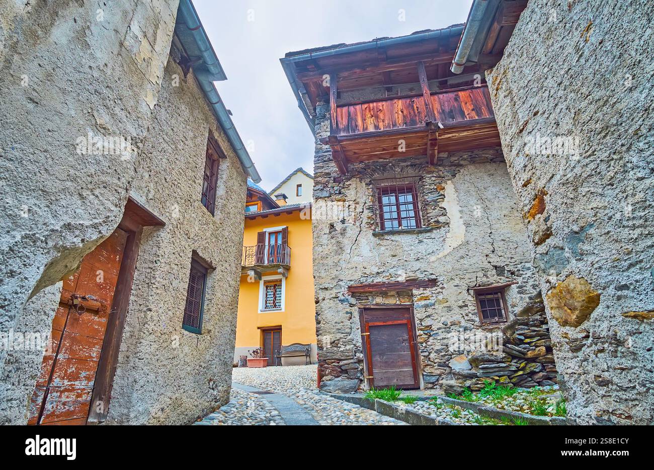 Walk up the narrow curved street of Peccia village, lined with vintage ...