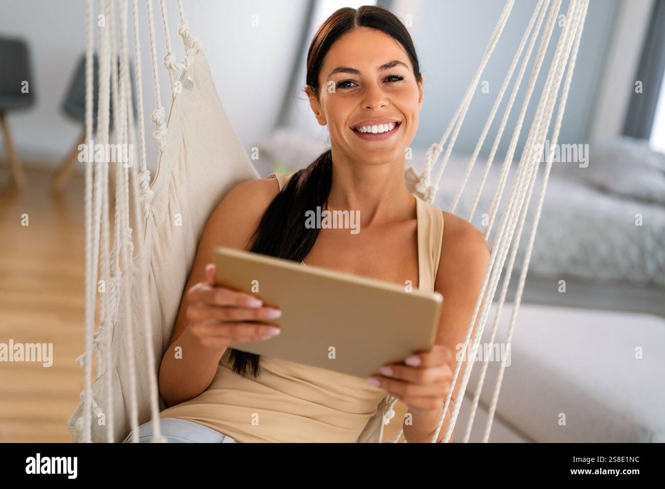 Happy beautiful woman watching videos or enjoying entertainment content ...