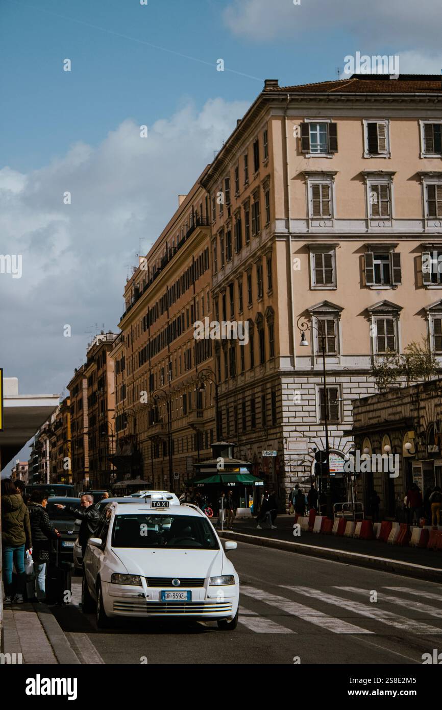 A typical afternoon in Rome: a white taxi parked along a bustling ...