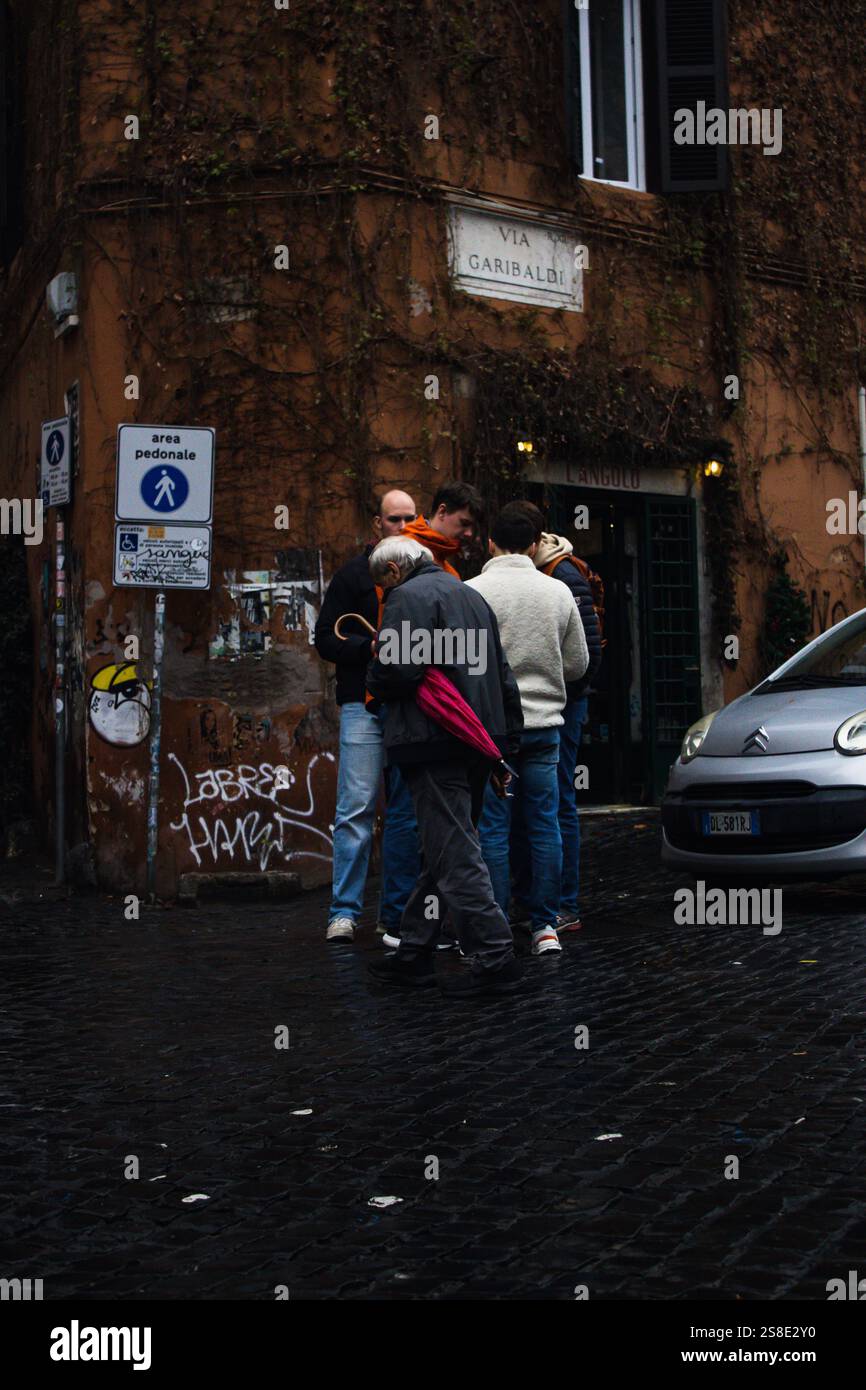 Local life unfolds on the old cobblestone streets of urban Rome, as ...