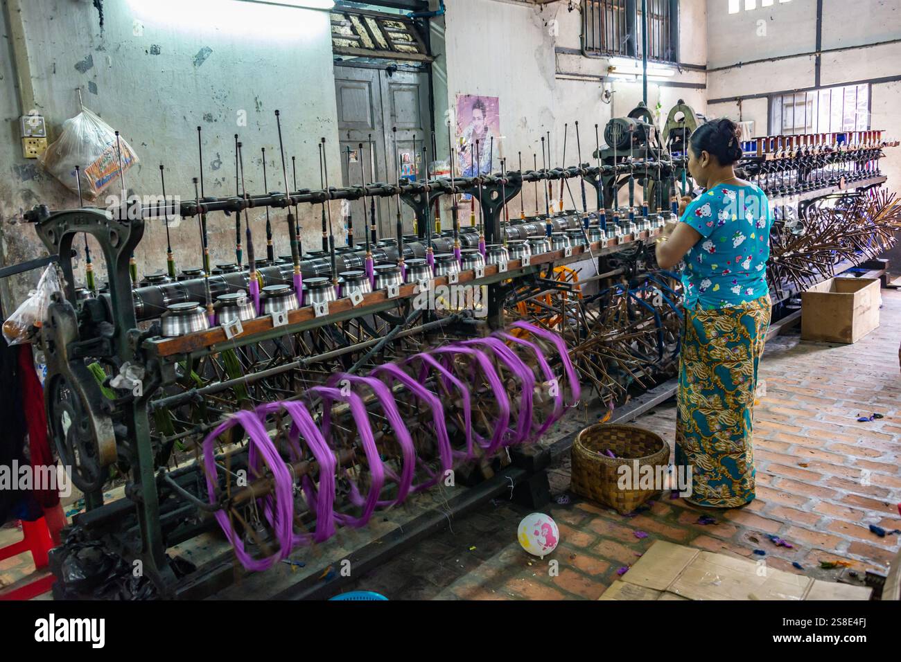 Woman working in silk weaving workshop, textile factory in Amarapura ...