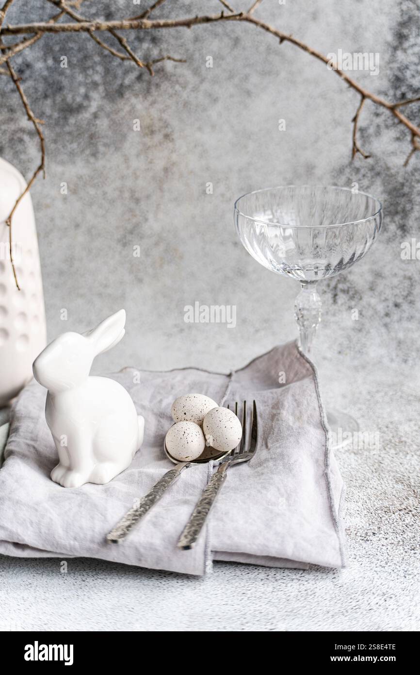 An elegant Easter-themed display featuring a white ceramic rabbit ...