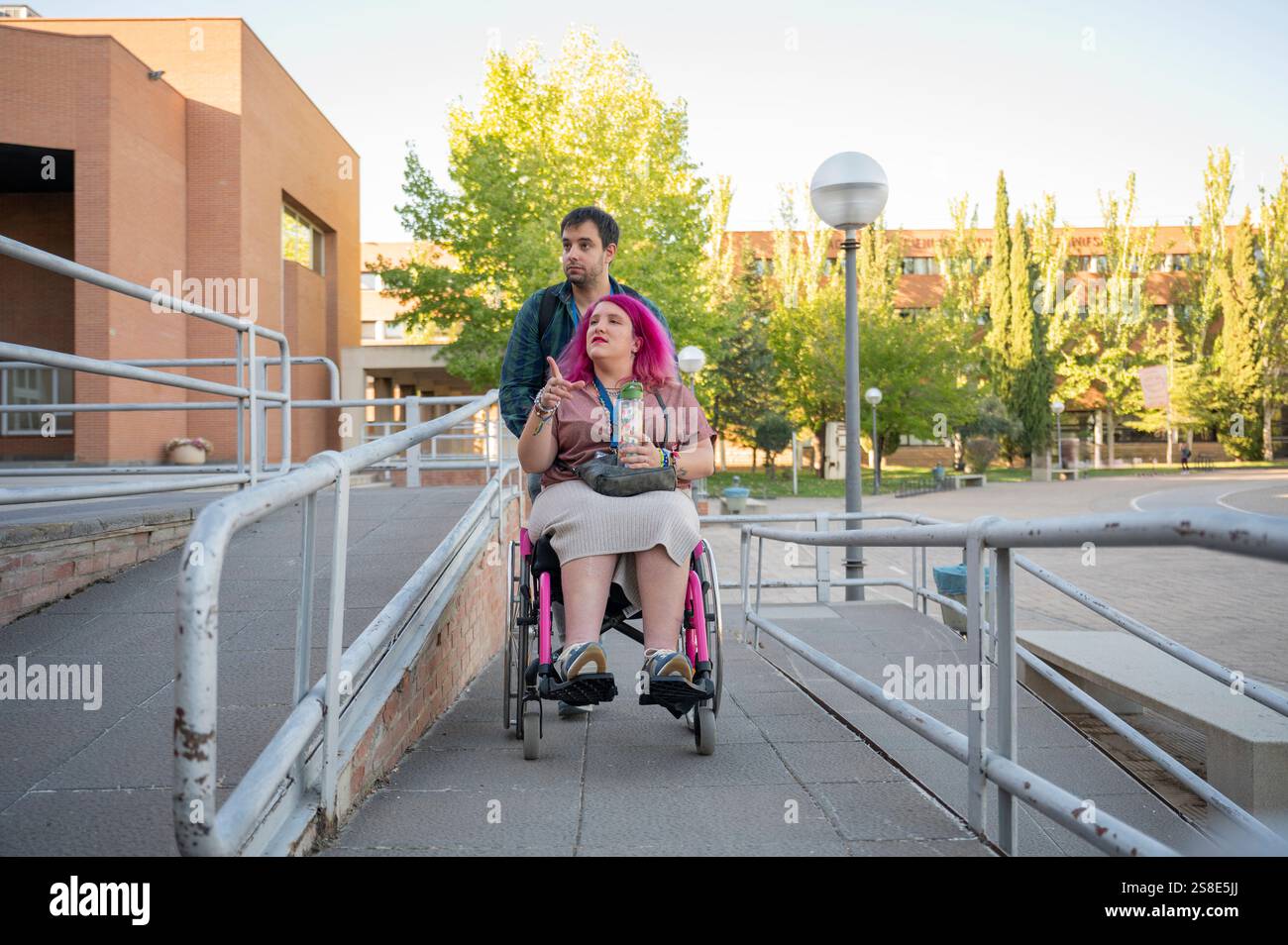 Couple at college, with the woman using a wheelchair due to spina ...