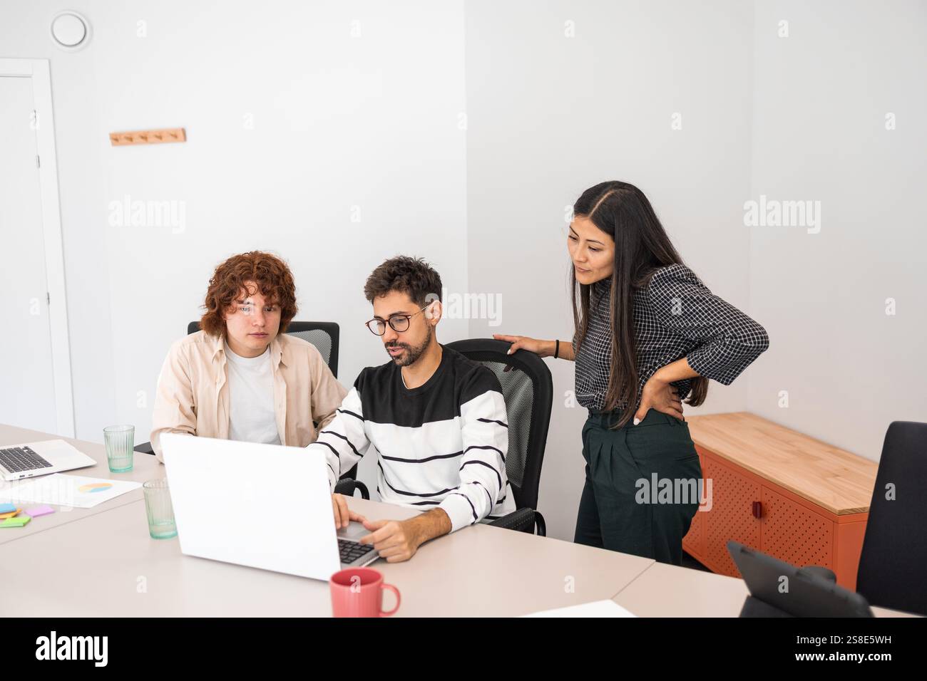 Diverse coworkers engage in collaborative work at a modern office A ...