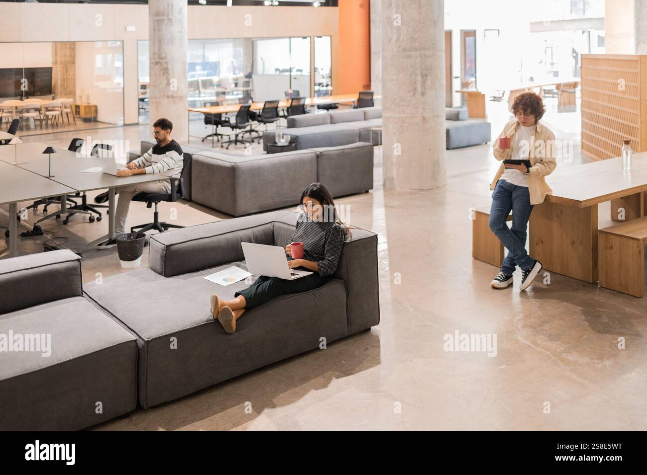 A contemporary open office space with professionals engaged in various ...