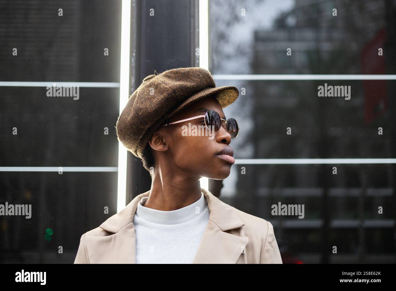 Stylish black woman in sunglasses and a brown hat, radiating urban elegance Captures modern ...