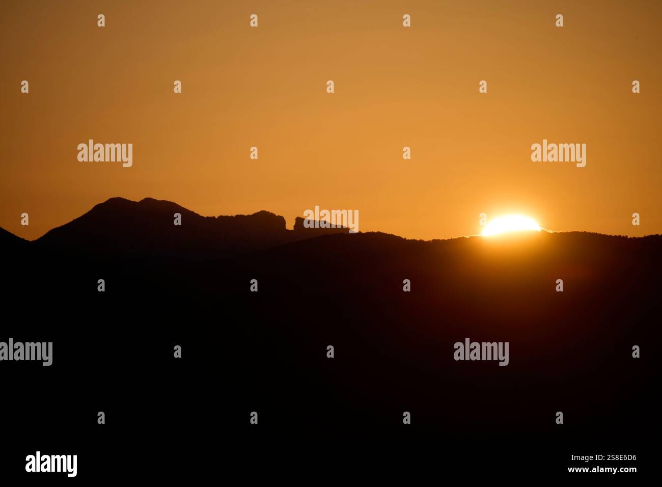 A breathtaking view of the sun rising over the silhouette of Alicante’s ...