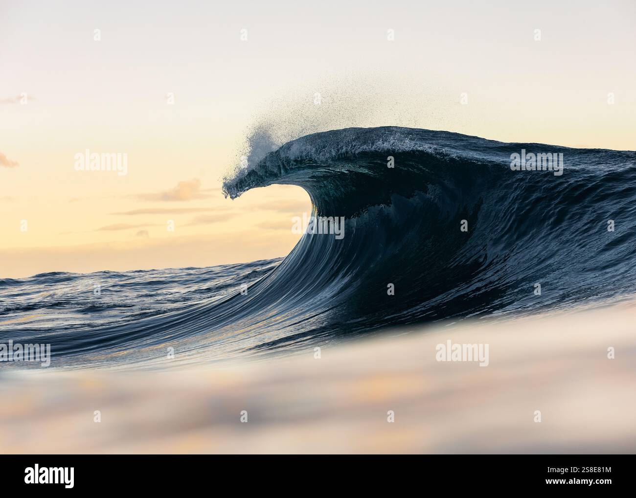 A mesmerizing ocean wave crests dramatically against the backdrop of a ...