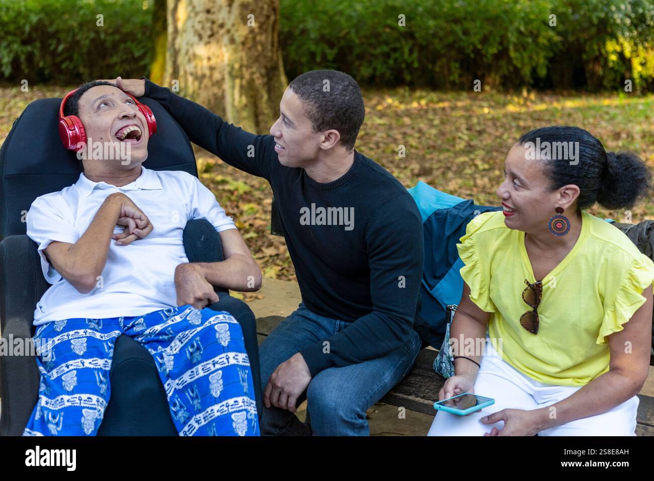 Spanish Cameroonian siblings share a joyful outdoor moment at a park ...