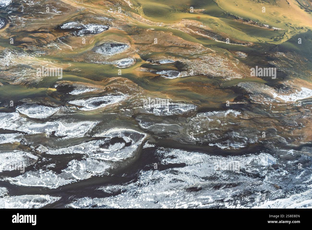 Aerial view of Icelandic rivers showcases a mesmerizing blend of colors ...