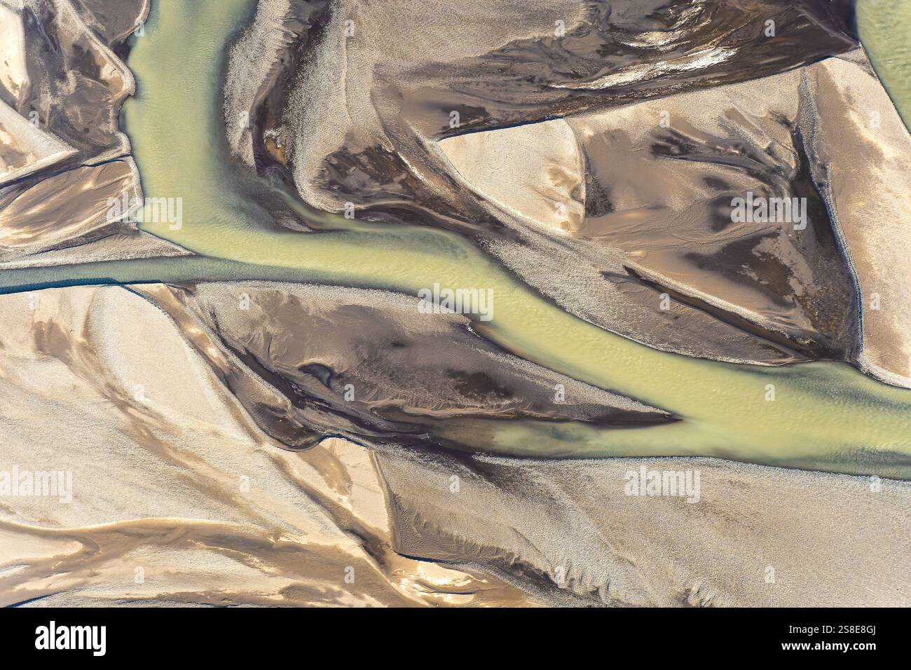 This stunning aerial photograph captures sinuous golden-tinted rivers ...