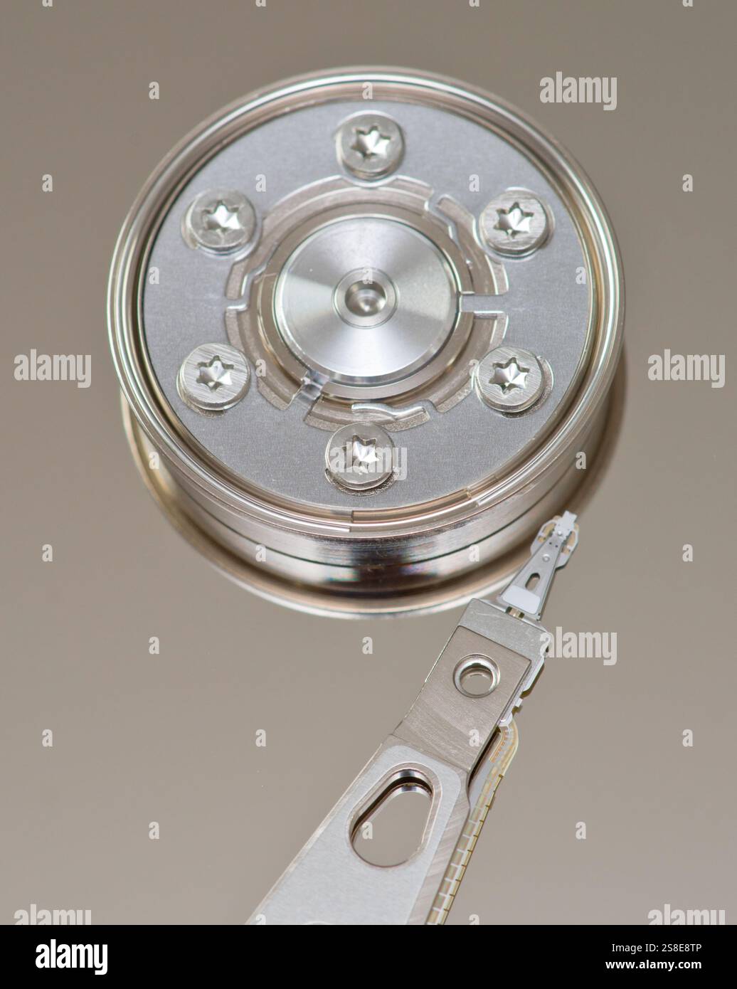 Detailed image showcasing a metallic hard drive arm positioned beside a ...