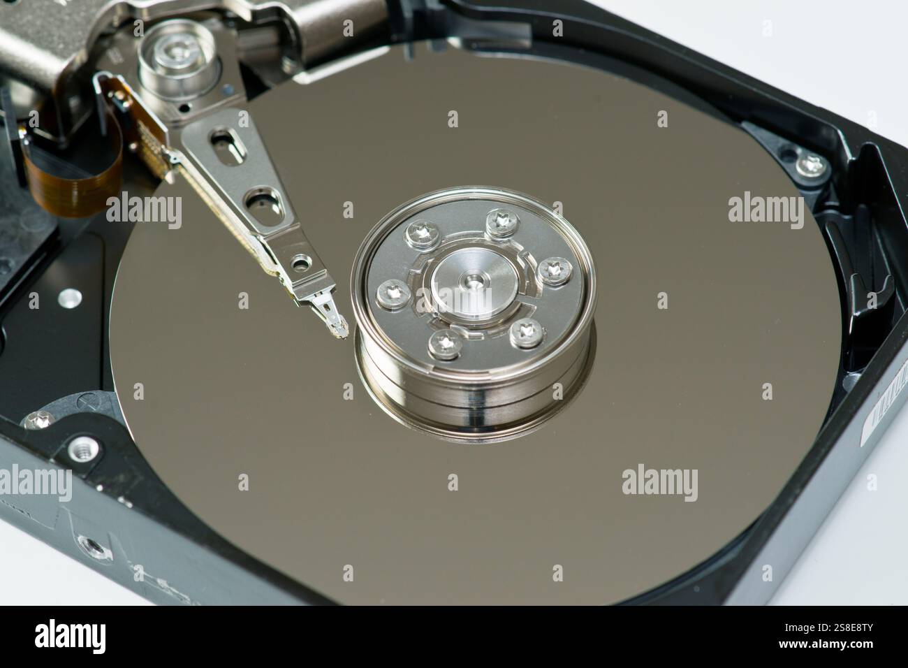 Detailed image showcasing the arm and platters of an open hard drive ...