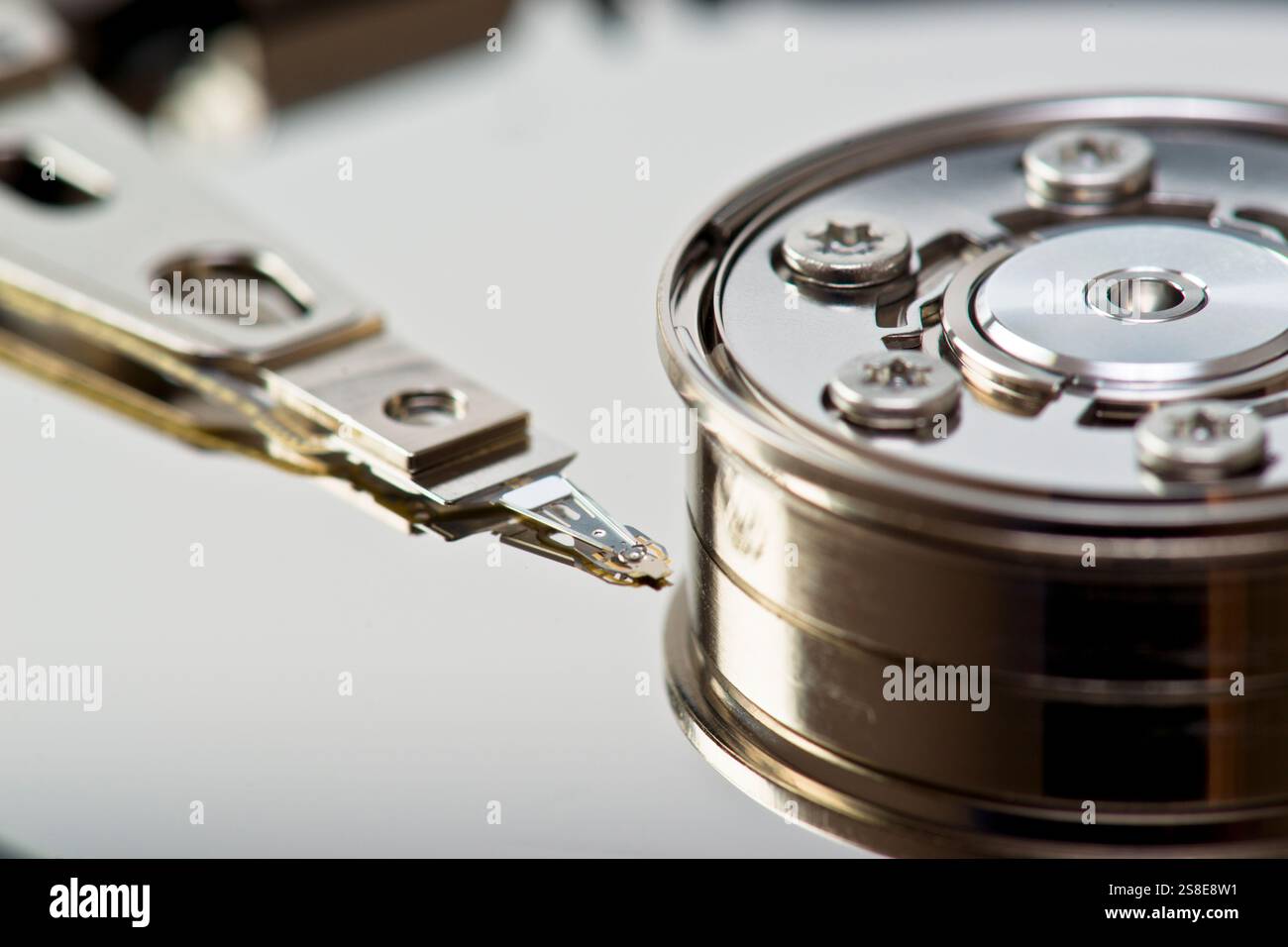 A detailed close-up image showing the read-write arm of a hard drive in ...