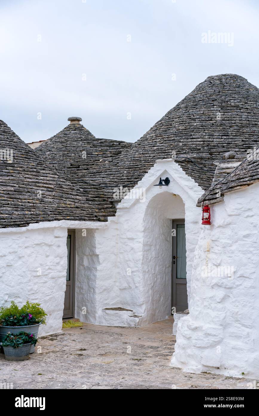 Traditional Trullo houses with whitewashed walls and conical stone ...