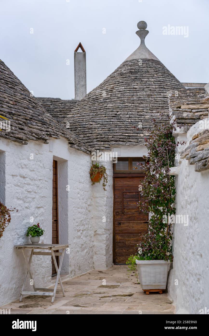 A cozy courtyard of a traditional Trullo house with whitewashed walls ...