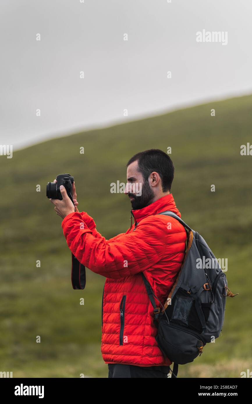 A traveler in a red jacket captures stunning photos on a road trip ...