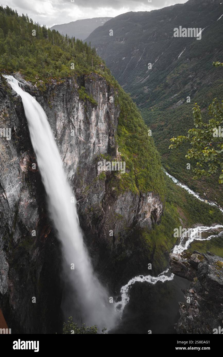 A breathtaking view of a mighty waterfall cascading down verdant cliffs ...