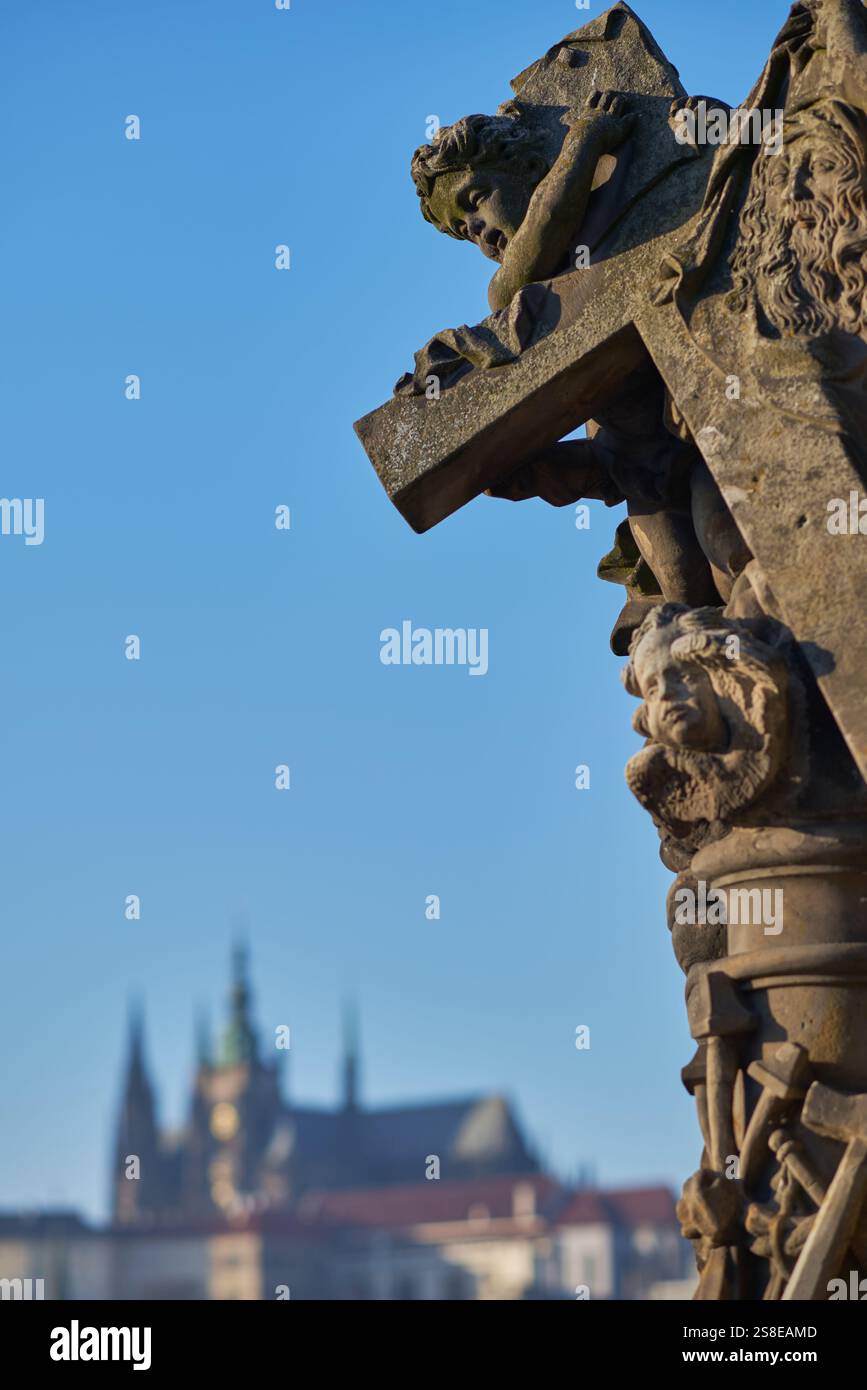 Religious statues mounted to the balustrade of Charles Bridge in Prague ...