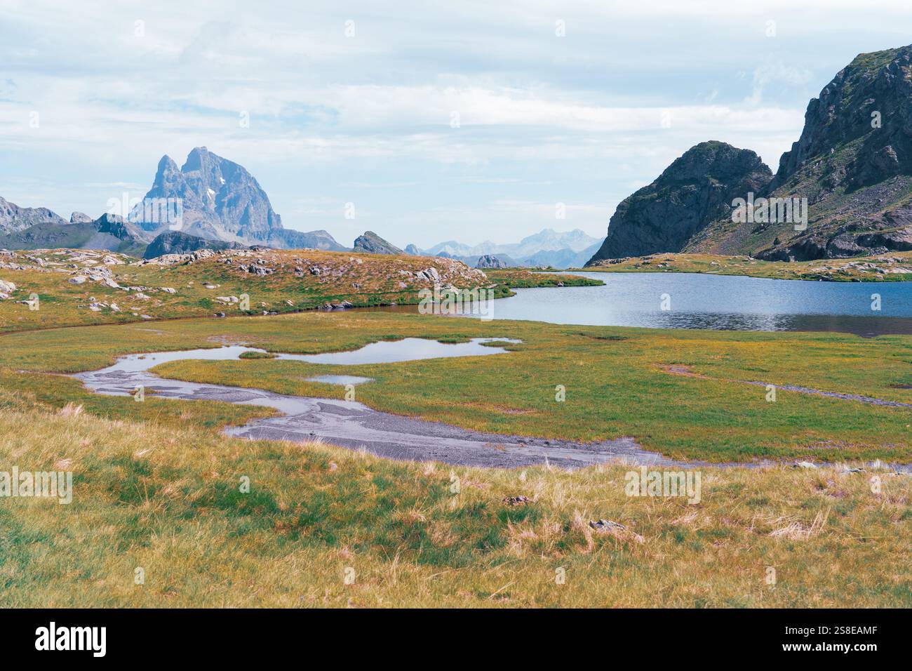 A captivating landscape image showcasing the tranquil Ibones de Anayet lakes surrounded by lush ...