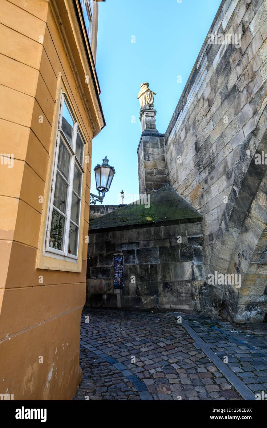 Religious statues mounted to the balustrade of Charles Bridge in Prague ...