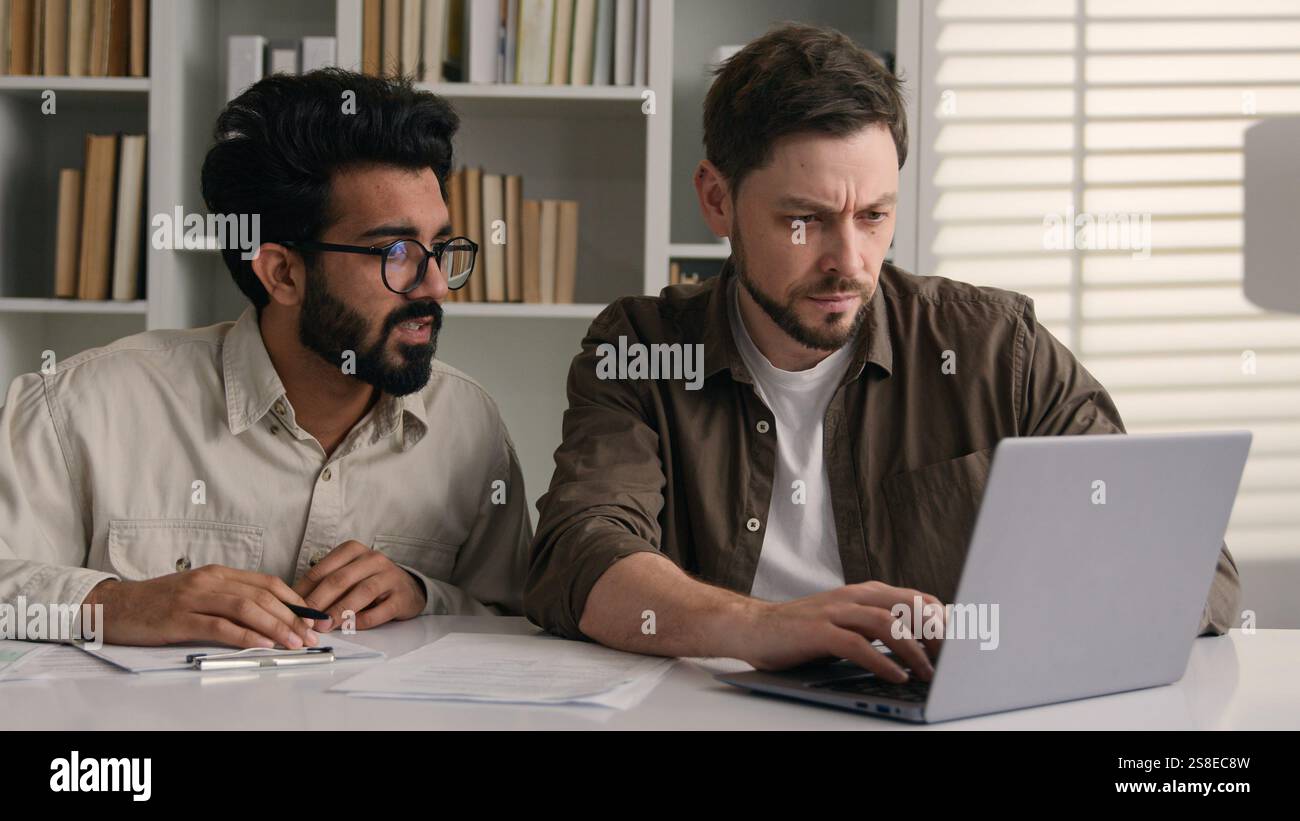 Two multiethnic colleagues businessmen business partners at office ...