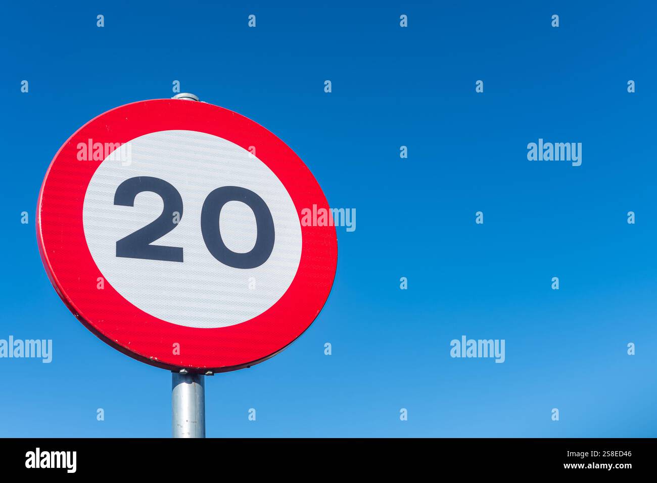 twenty kilometers per hour speed limit sign with blue sky background ...