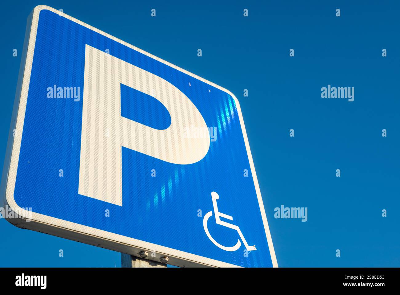 parking space sign for drivers with special necessities with a blue sky ...