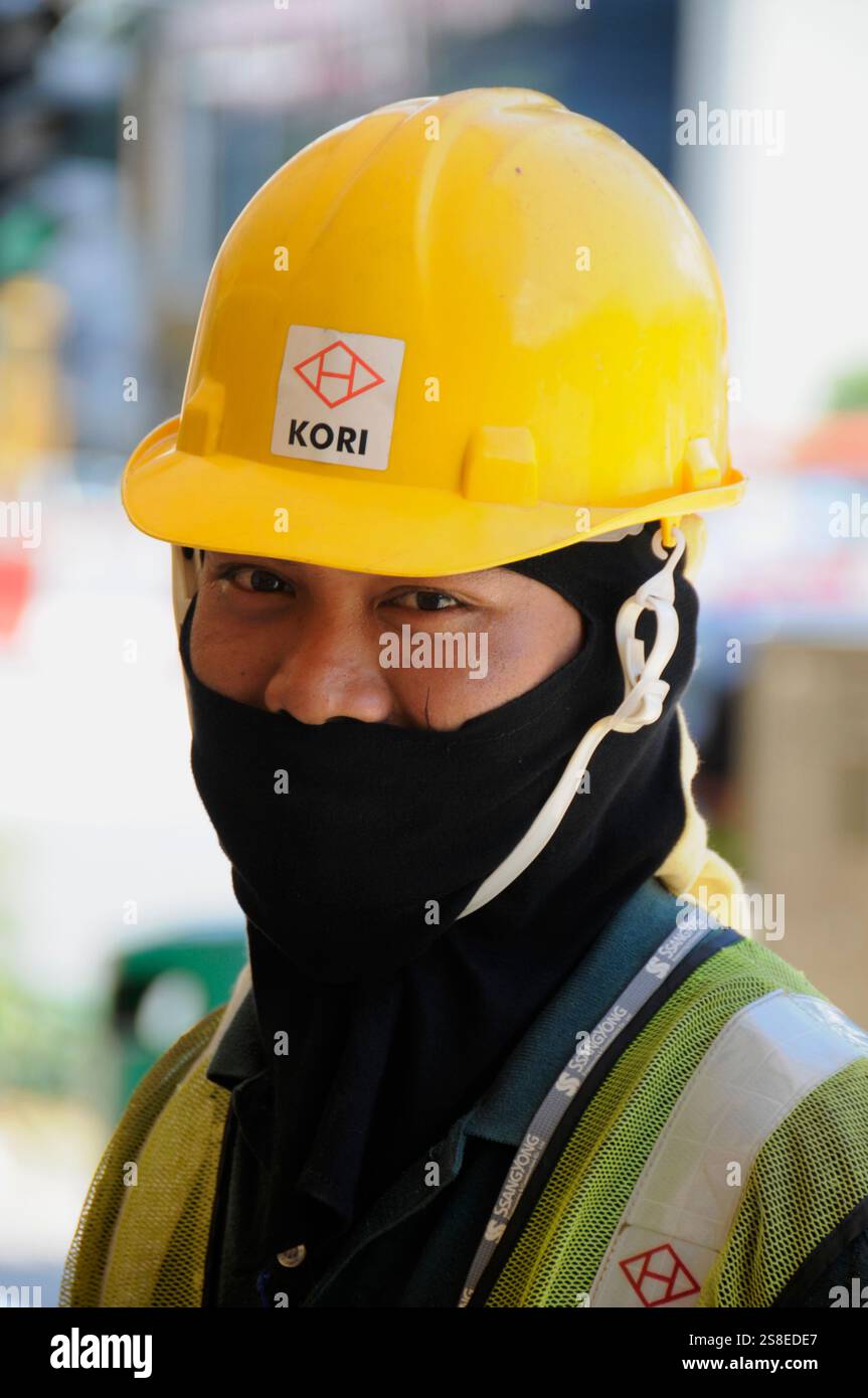 One of the many Asian building labourers working on construction sites ...