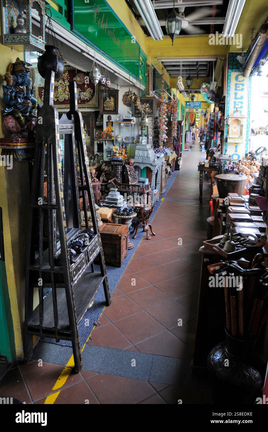 An alley lined with Indian wood carvings shops in 'Little India' in ...