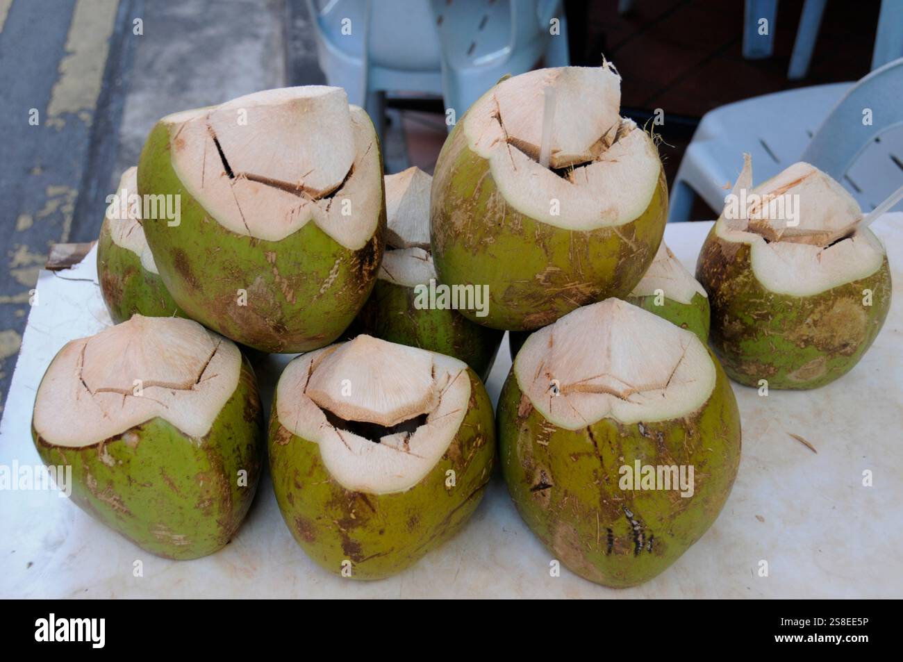Coconuts on sale ready to drink at a coconut stall in Little India ...