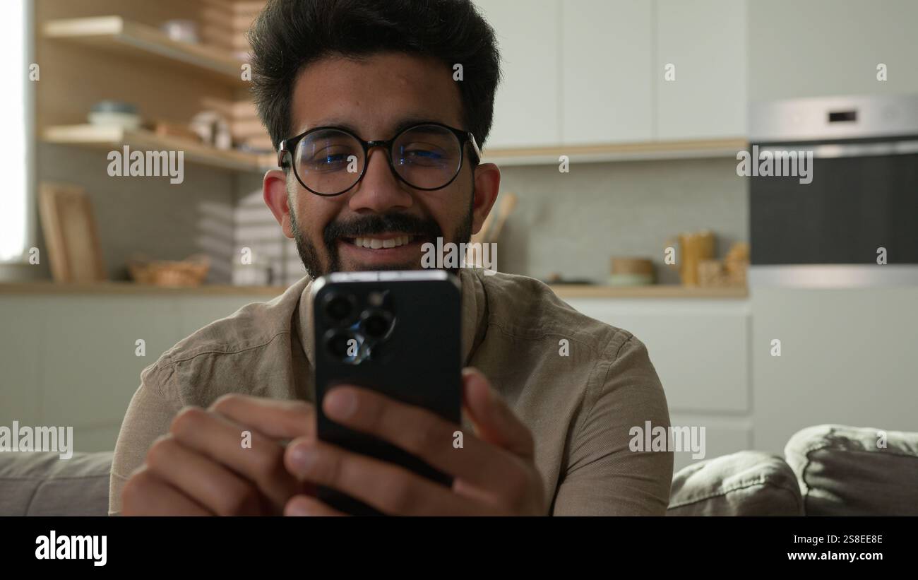 Arabian Indian man guy happy smiling male freelancer relaxing on couch ...