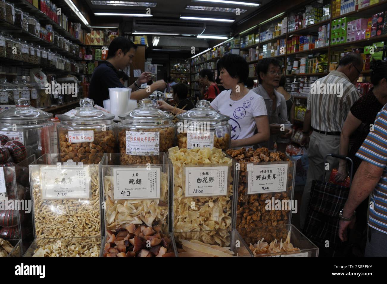 A row of large jars filled with a mix of Chinese dried fish and sea ...