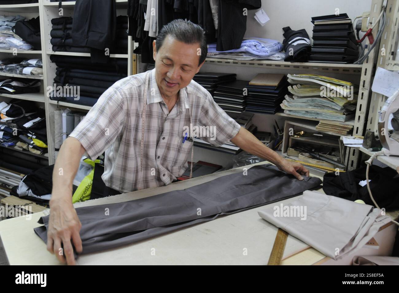 A Chinese tailor in an open front shop in Singapore Stock Photo - Alamy