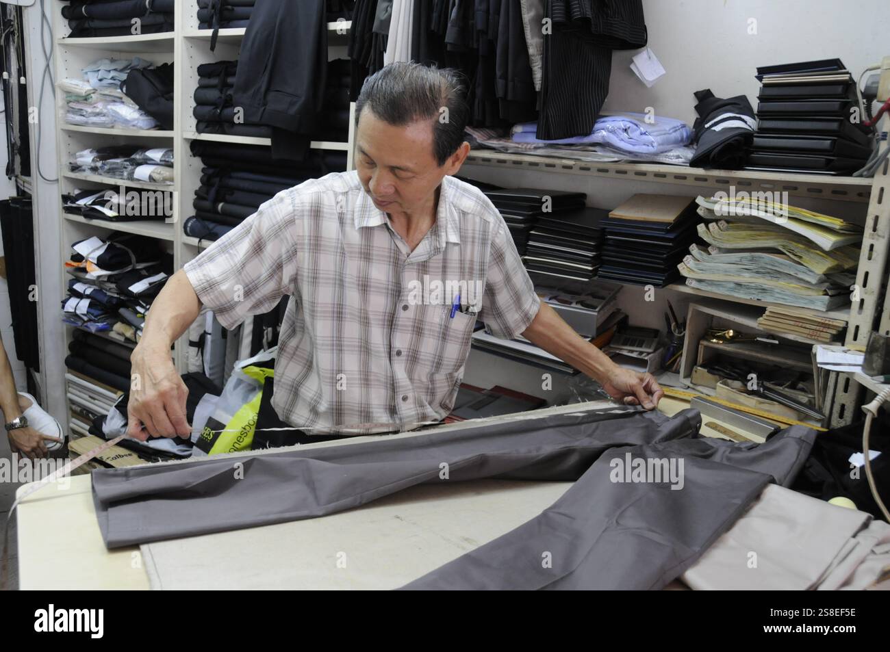 A Chinese tailor in an open front shop in Singapore Stock Photo - Alamy
