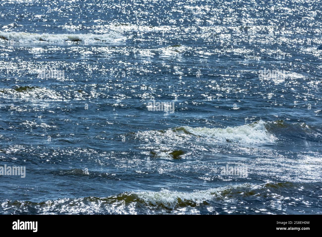 Shiny blue sea water with bright reflections of sunlight, natural ...