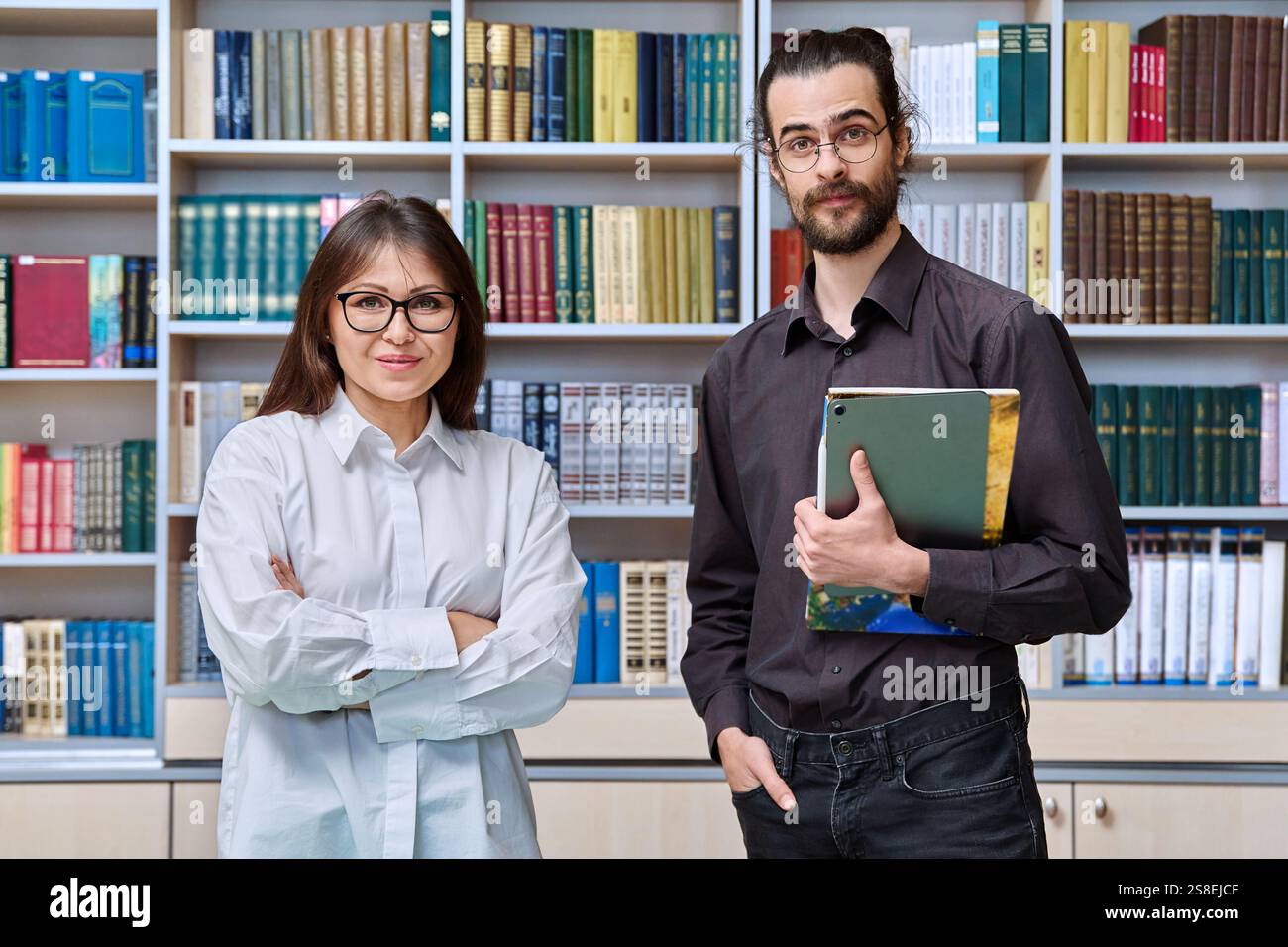 Portrait of man and woman colleagues educators teachers inside ...