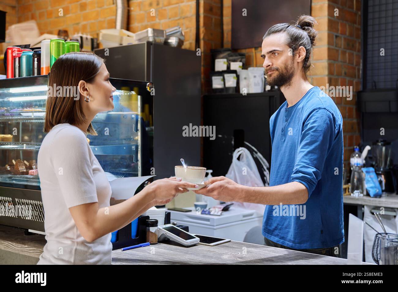 Young man cafe worker shaking hands with woman client customer ...