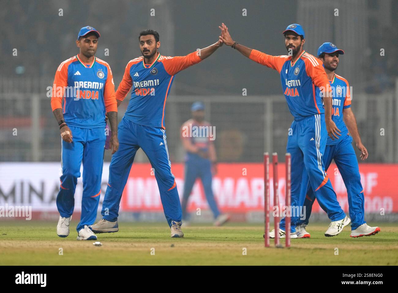 India's Axar Patel, second left, celebrates with teammates after the ...