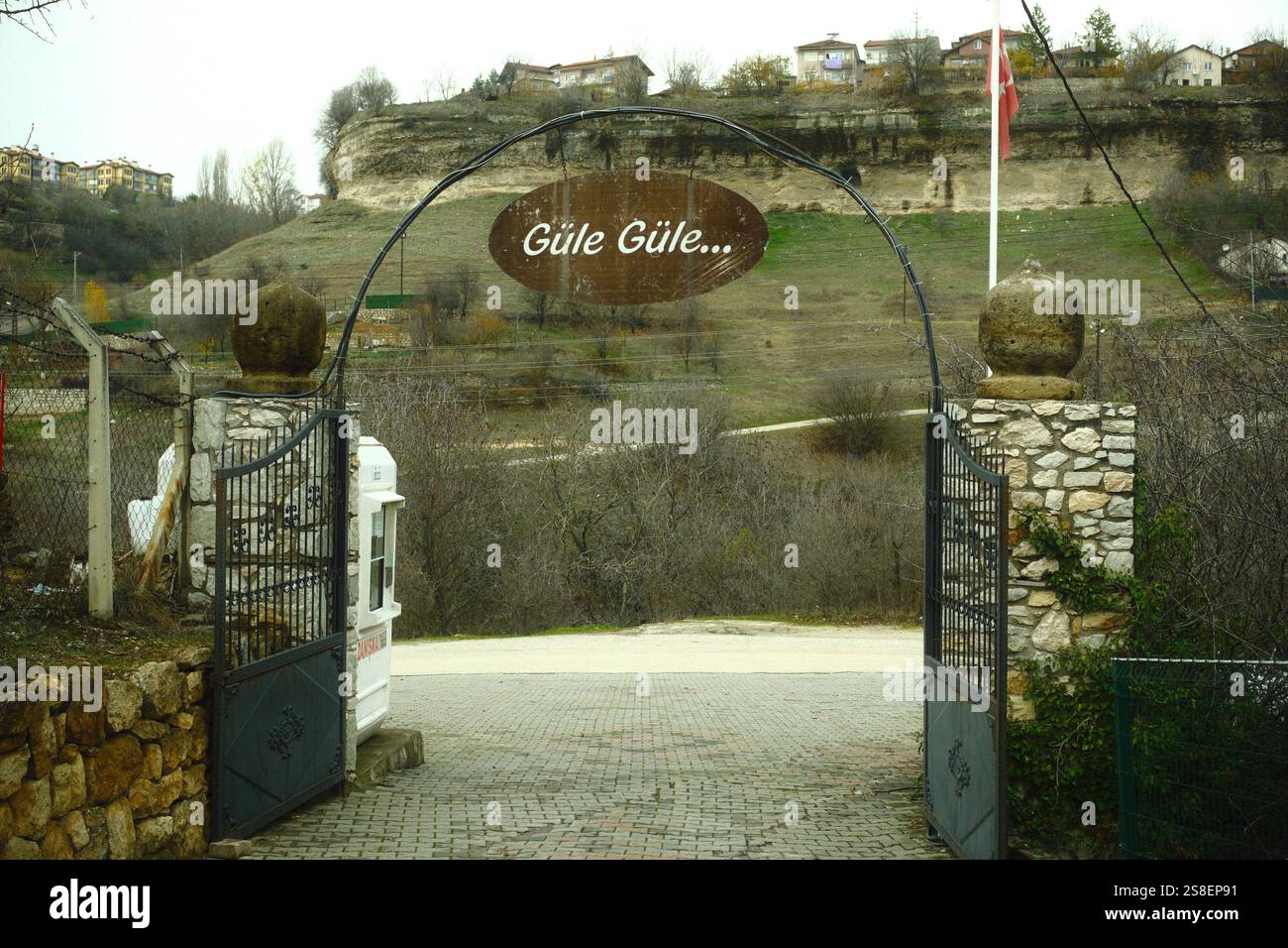 Rustic wrought iron gate in a countryside village with a signboard ...