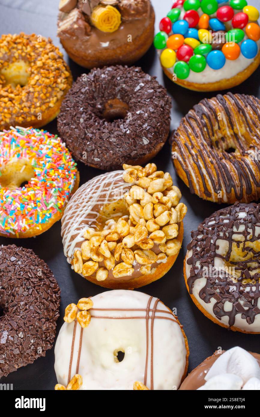 Assorted donuts from above on black background Stock Photo - Alamy