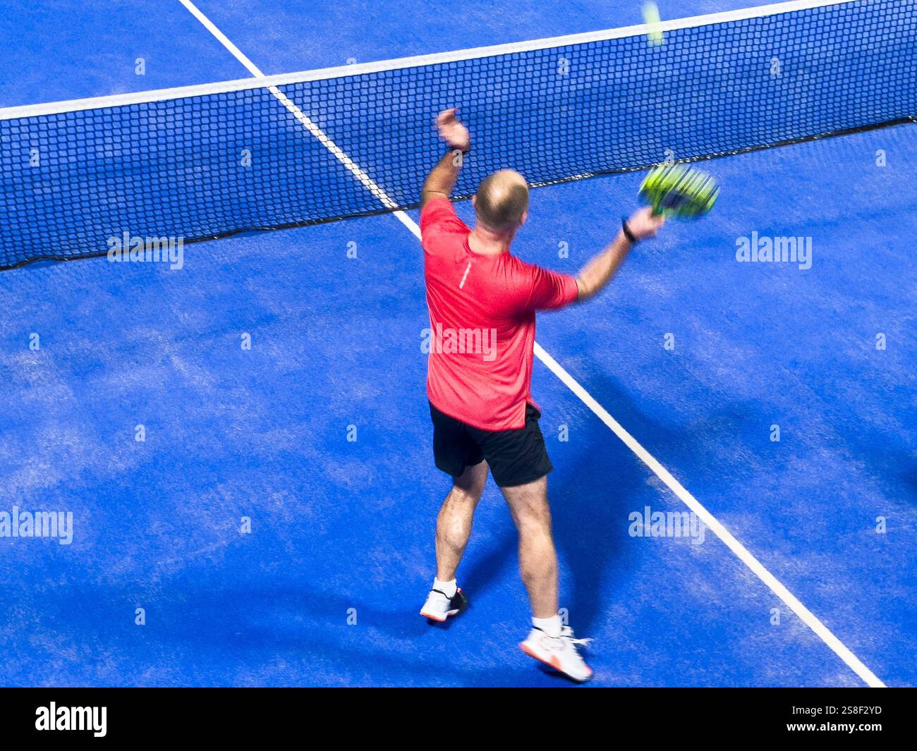 Padel match in a blue grass padel court - Padel player playing a match ...