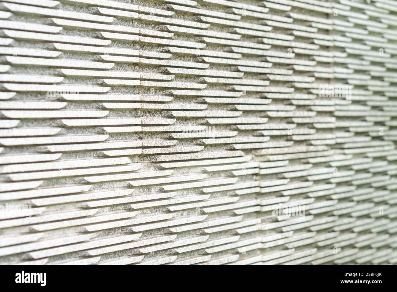 A close-up view of a textured wall featuring a pattern of horizontal and vertical grooves ...