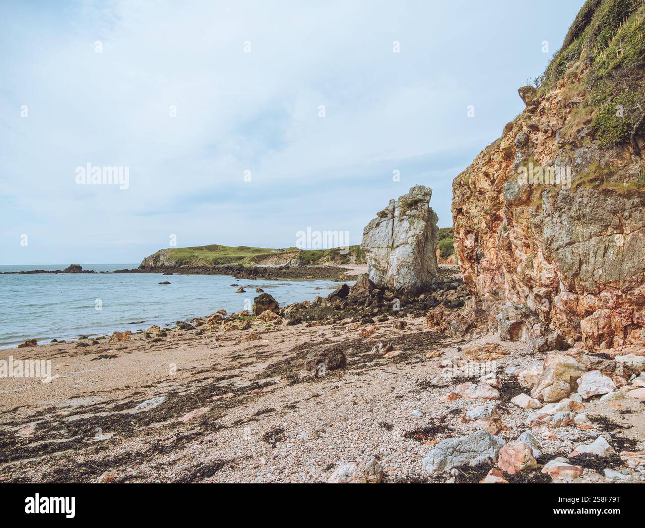 The beach of Porth Padrig in Anglesey, Wales, with a large rock ...
