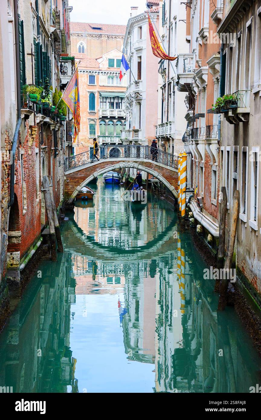 Venice gondola tour. Canal scene. Tourists enjoying gondola ride during ...