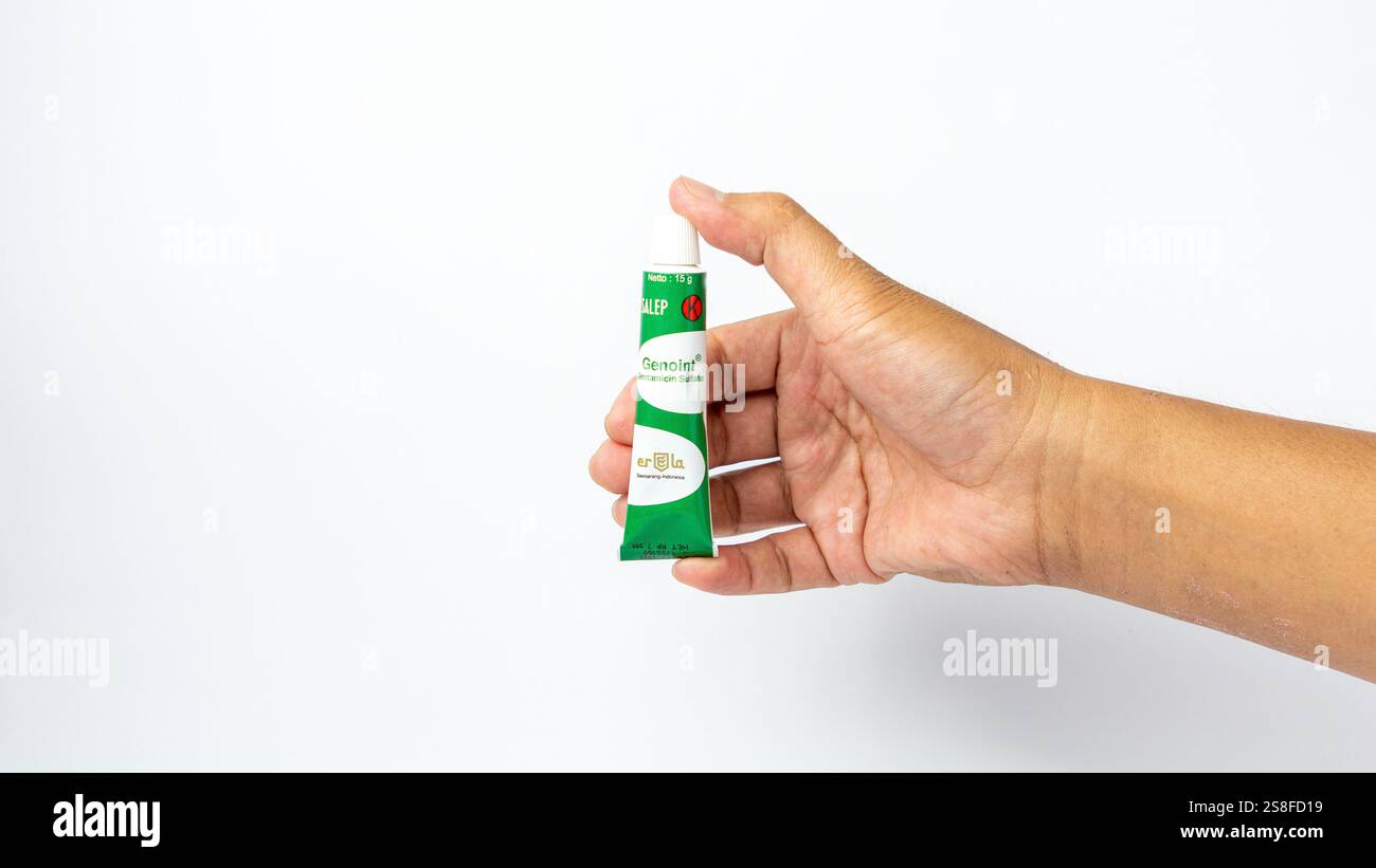 Hand holding genoint. Genoint is an eye drop, eye ointment and skin ...