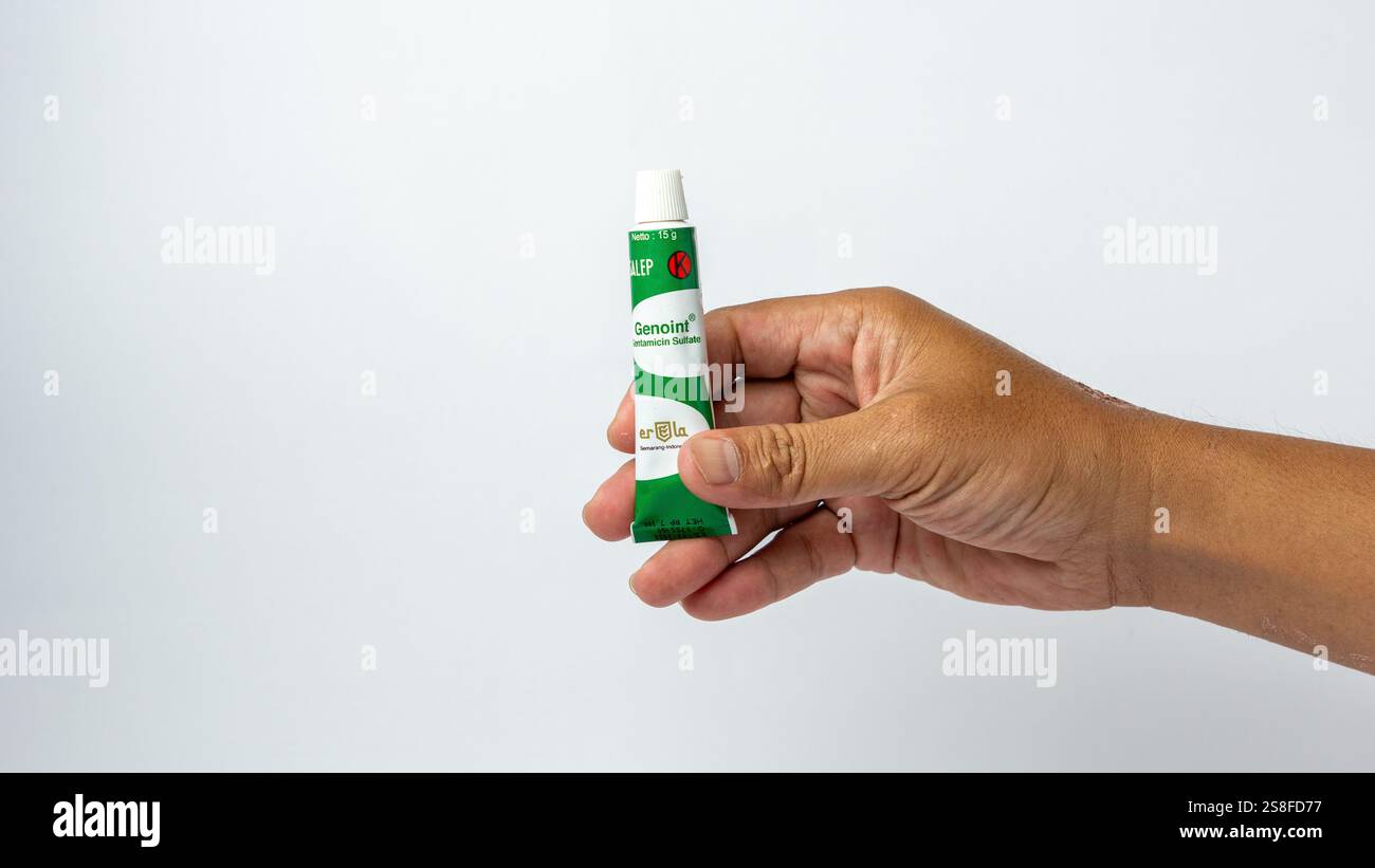 Hand holding genoint. Genoint is an eye drop, eye ointment and skin ...